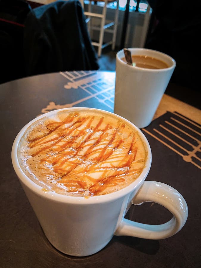 White Ceramics Mug Filled with Coffee and a Nice Decorated Crema on Top ...