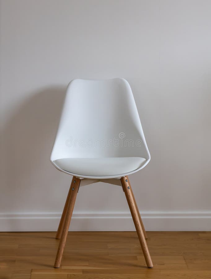 Empty White Chair Against a Plain Wall Stock Photo - Image of ...