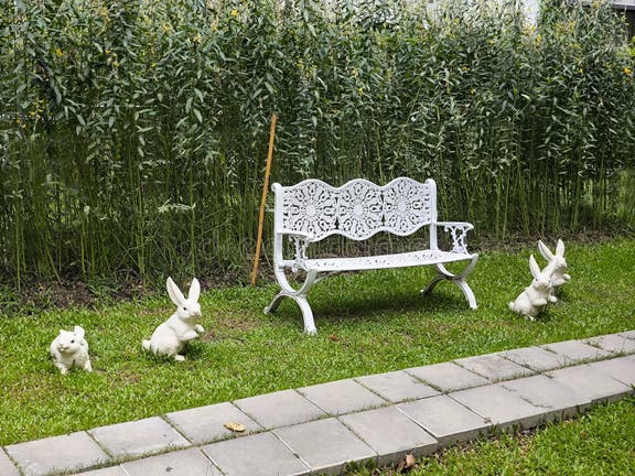 A White Chairs and White Rabbit Statue on the Garden Stock Image ...