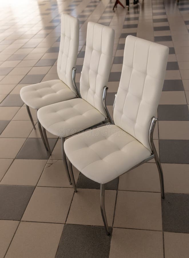White Chairs Stand on Tiles in the Room Stock Photo - Image of brown ...