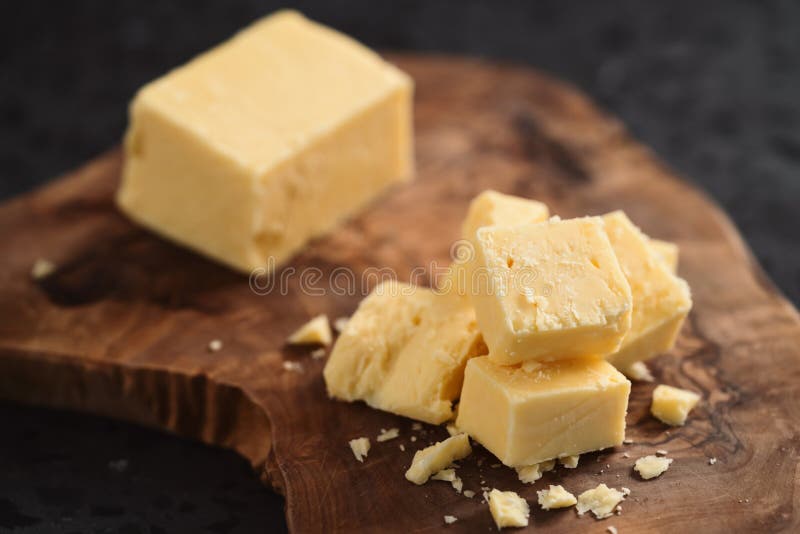White Cheddar Cheese Pieces on Olive Wood Board Stock Photo - Image of ...