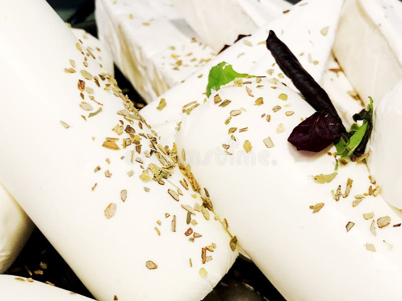 White Cheese Sliced Slices on a Plate Torn with Greens and Spices ...