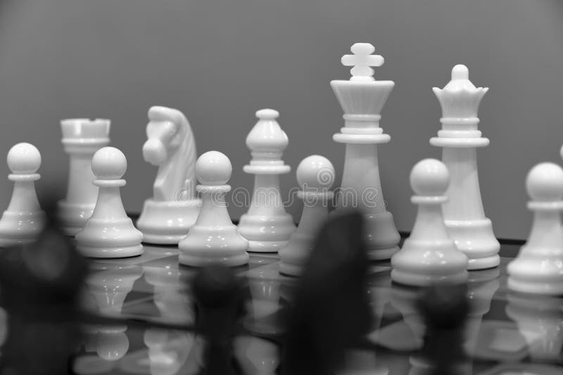 White Chess Pieces Against Background Black Blurred Chess Pieces. Stock ...