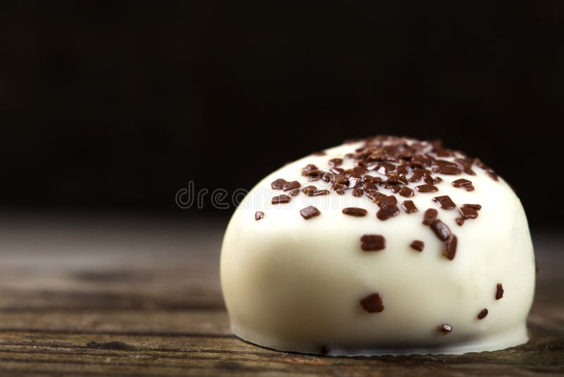White Chocolat Candy with Small Pieces of Dark Chocolate Over Wood ...
