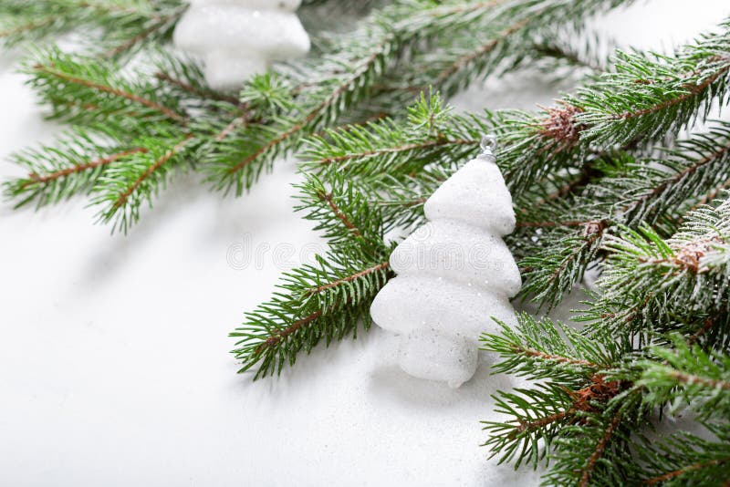 White Christmas Tree and Green Branches on Light Surface Holiday ...
