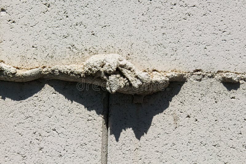 White Cinder Block Wall with Oozing Concrete, and Cracks on the Blocks ...