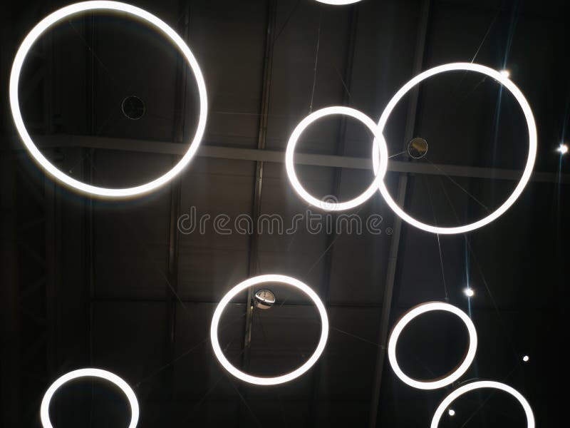 White Circular Ring Shaped Lamps Hang Under a Concrete Ceiling Stock ...