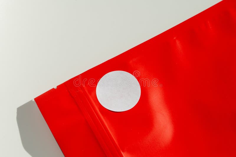 White Circular Sticker on Red Poly Mailer Envelope with Natural Shadow ...
