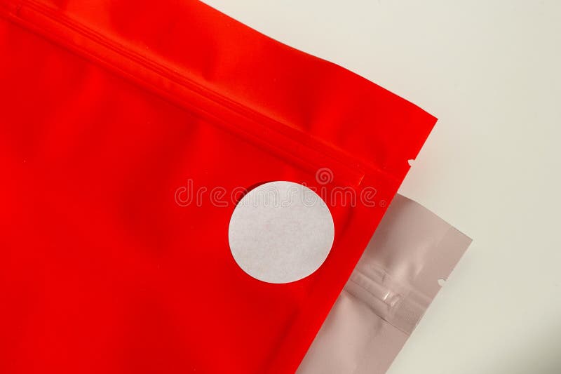 White Circular Sticker on Red Poly Mailer Envelope with Natural Shadow ...