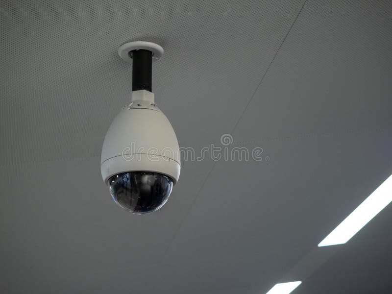 White Circular Surveillance Camera on Ceiling in a Public Setting ...