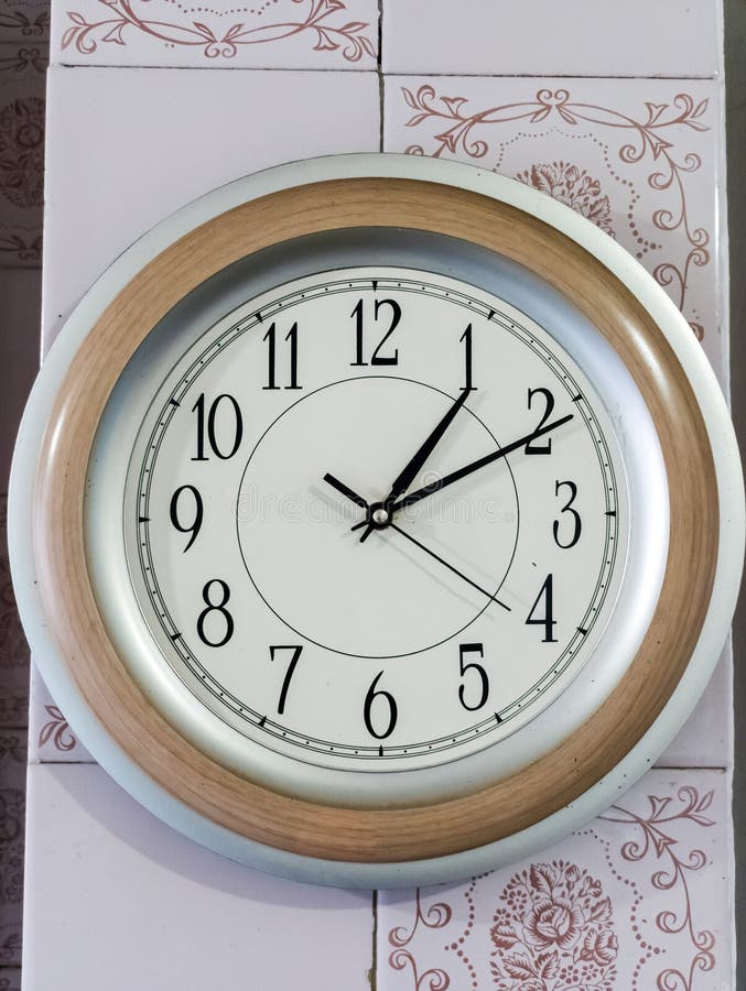 A White Clock with Black Hands on a Wall Stock Image - Image of clock, hands: 405443903