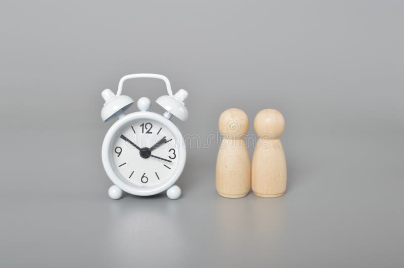 White Clock and Wooden Figures. Project Management, Team Work and Time ...