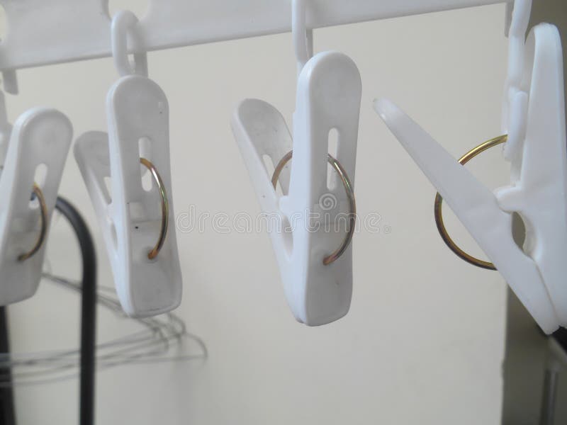 White Cloth Pins Hanging on Drying Rack Stock Photo - Image of clip ...