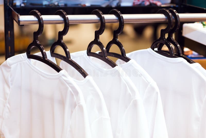 White Clothes Hanging on Hangers in a Store Stock Image - Image of ...