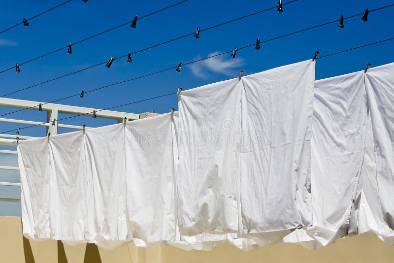 White Clothes Hanging on the Line Against Blue Sky. Stock Photo - Image ...