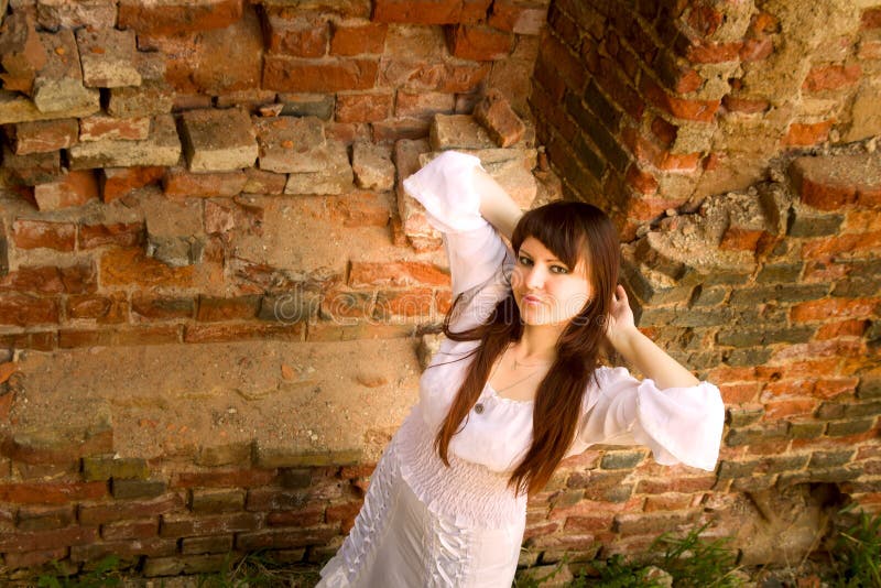 White Clothes On A Young Girl On Brick Wall Background Stock Image