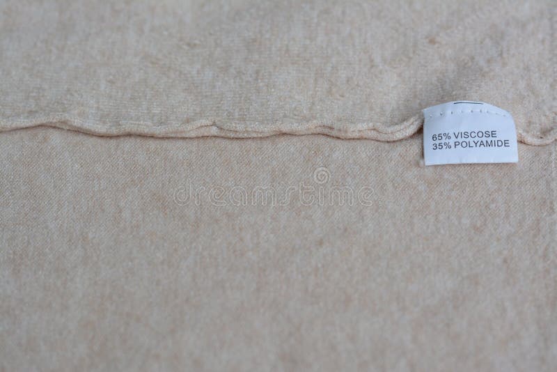 White Clothing Label with Care Information on Beige Garment, Space for ...