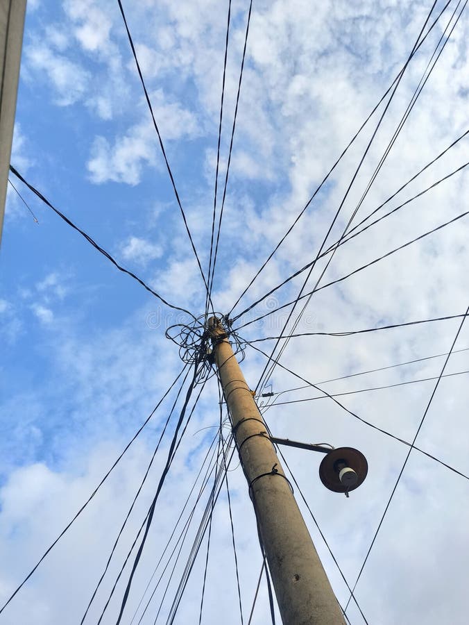 White Clouds and Blue Sky Obstructed by Tangled Power Lines Stock Image ...