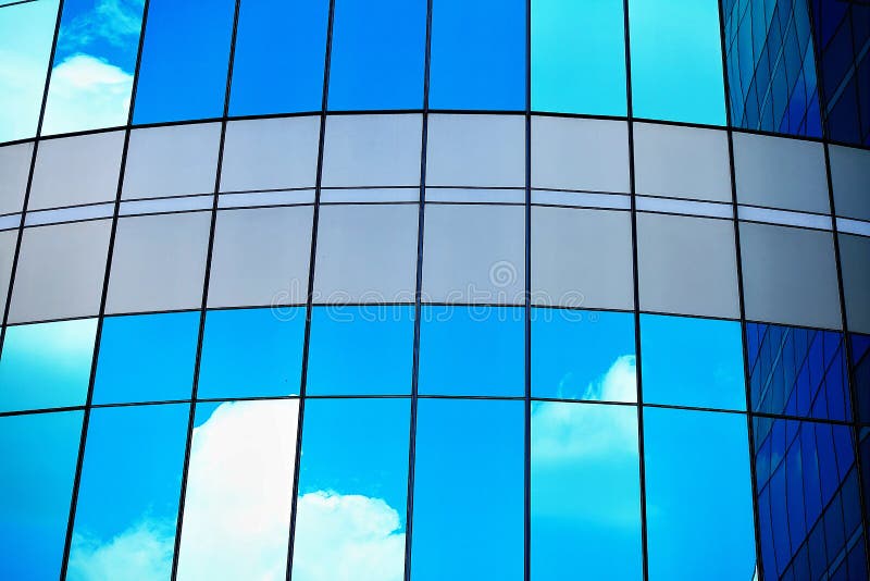 White Clouds Reflect Sunlight on Tall Glass Blue Abstract Crop of ...