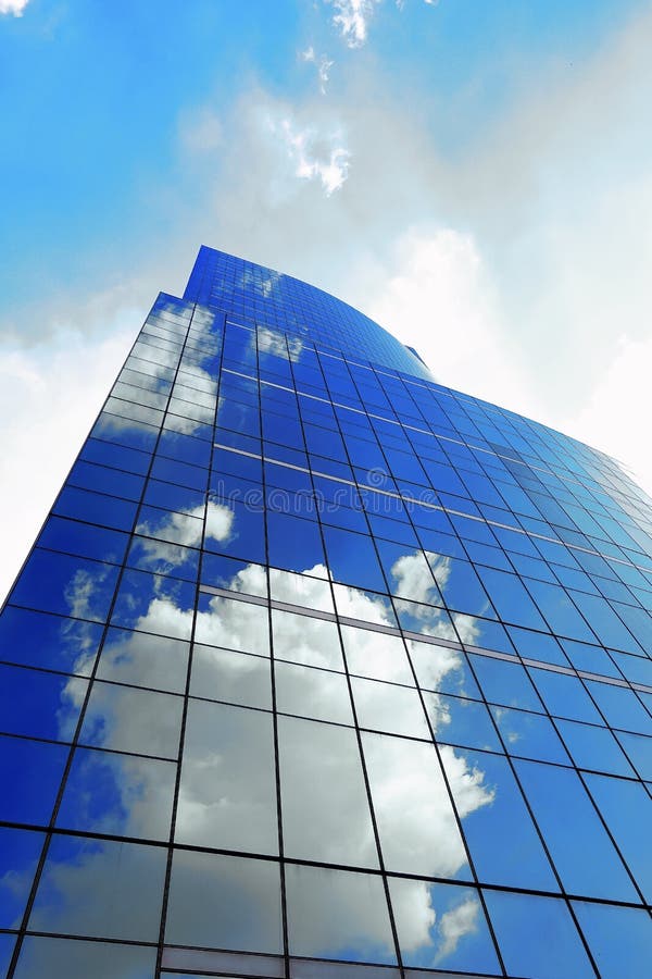 White Clouds Reflect Sunlight on Tall Glass Blue Abstract Crop of ...
