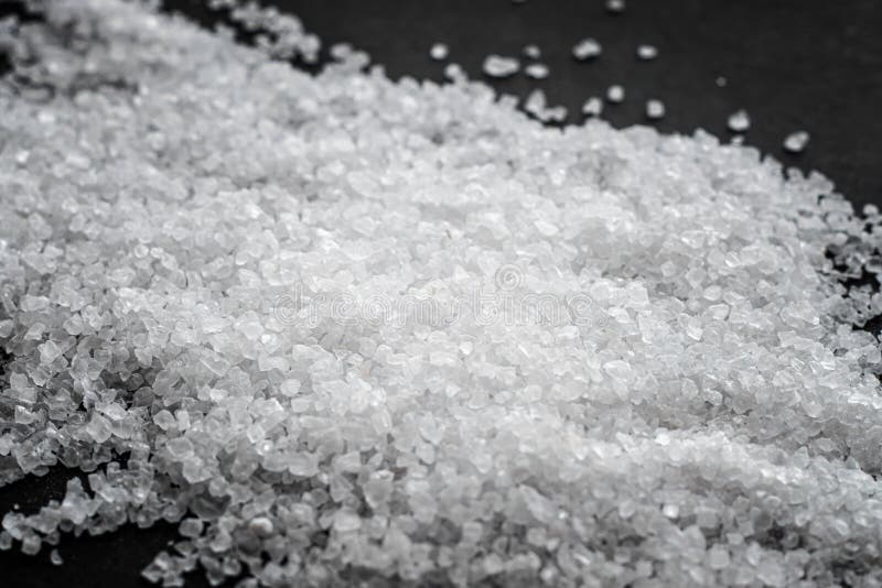 White Coarse Sea Salt on a Black Background Stock Photo - Image of ...