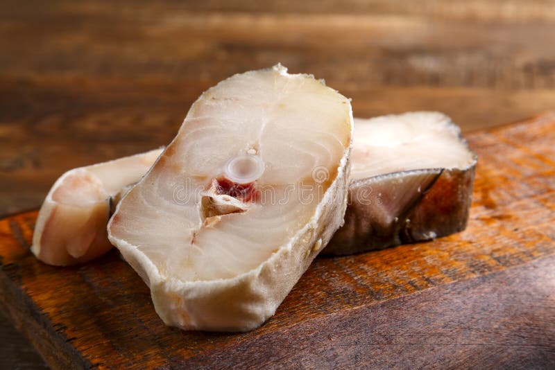 White Cod Fish Steaks on a Wooden Board. Stock Image - Image of tomato ...