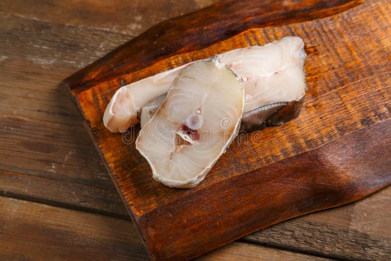 White Cod Fish Steaks on a Wooden Board. Stock Photo - Image of fillet ...