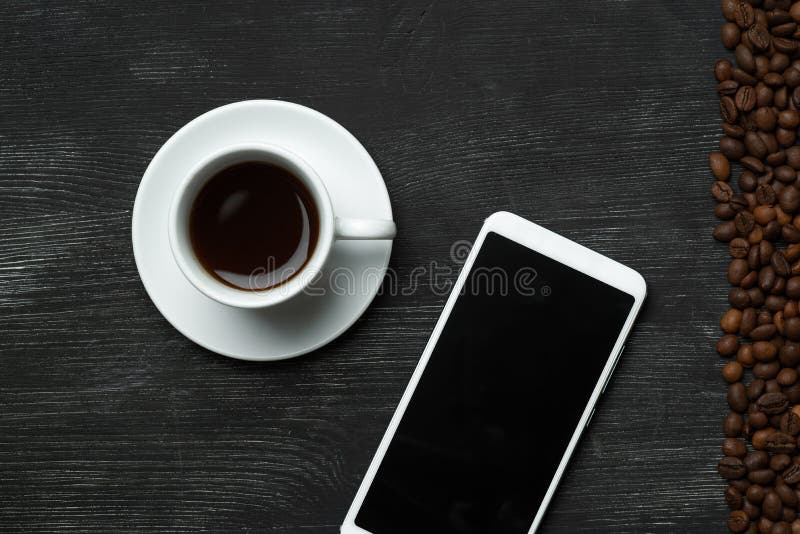 White Coffee Cup with White Mobile Phone and Coffee Beans on the Right ...