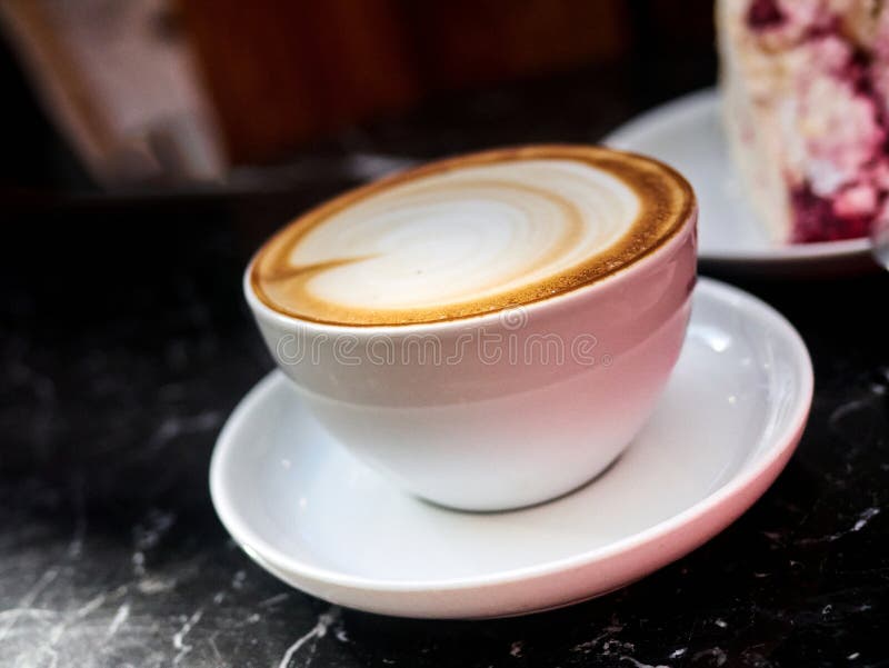 A White Coffee Cup with a White Saucer Sits on a Table Stock Image ...
