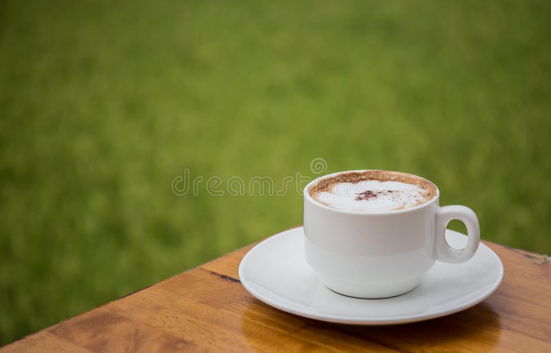 A White Coffee Cup on a Wooden Table with a Backdrop of Rice Fields ...