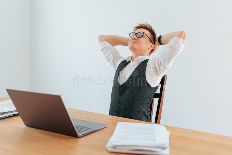 A White Collar Worker Sitting Alone in His Office, Smiling with ...