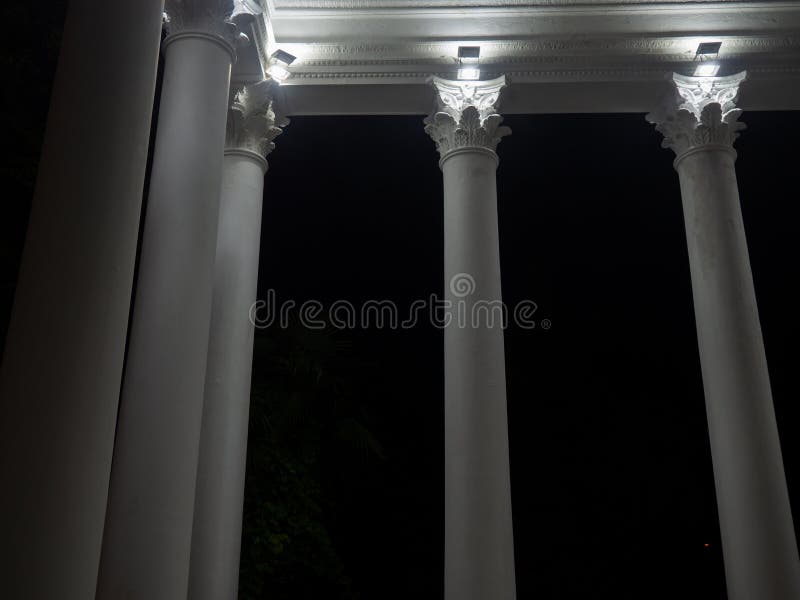 White Colonnade in the Dark. White Columns in the Light of Spotlights ...