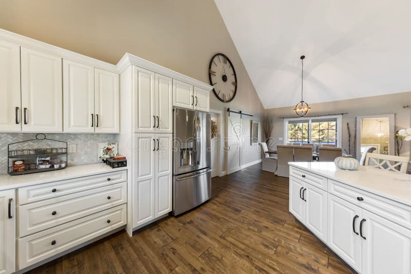 White Color Themed Kitchen Interior with Hardwood Floor Stock Photo ...