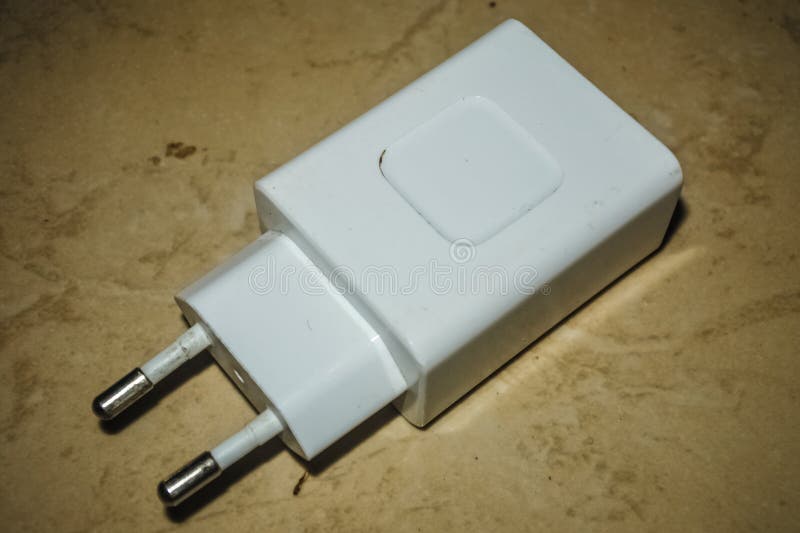 White Compact Plug Adapter for Electronic Devices on Beige Surface ...