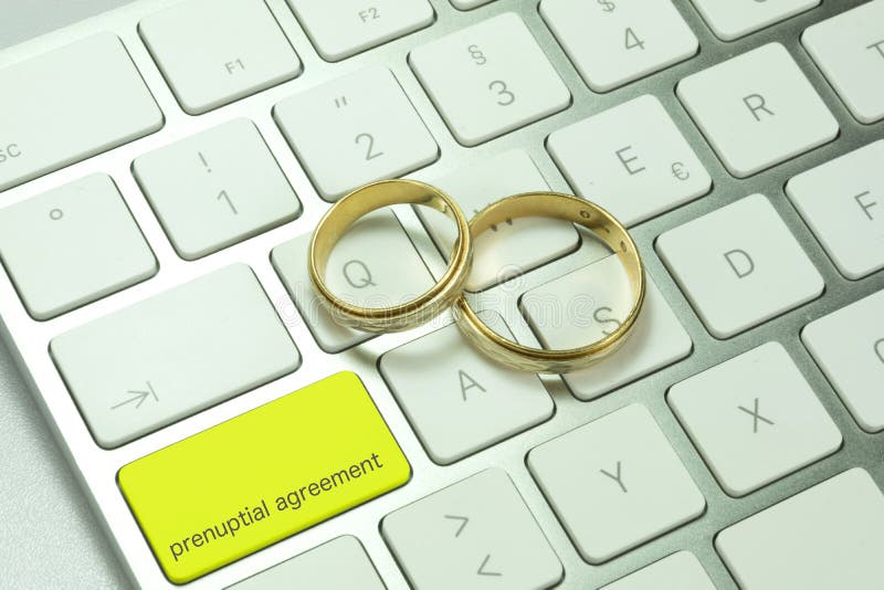 A Computer with a Button for a Marriage Contract and Two Wedding Rings ...