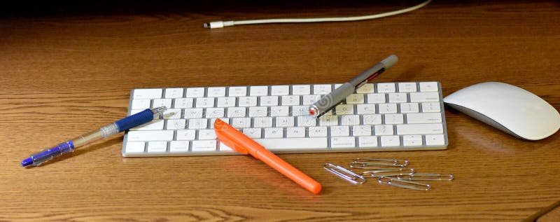 White Computer Keyboard with Paper Clips, Pen, Highlighter and Mouse ...