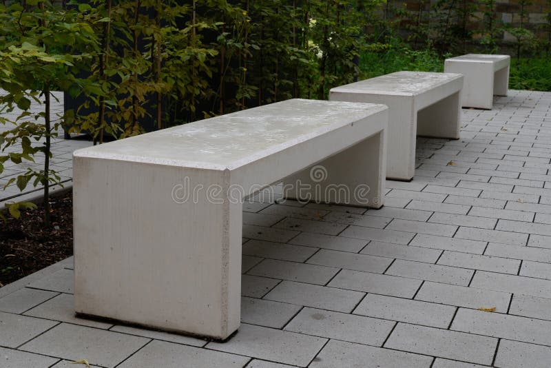 White Concrete Benches on the Sidewalk, they Have the Same Heights and ...