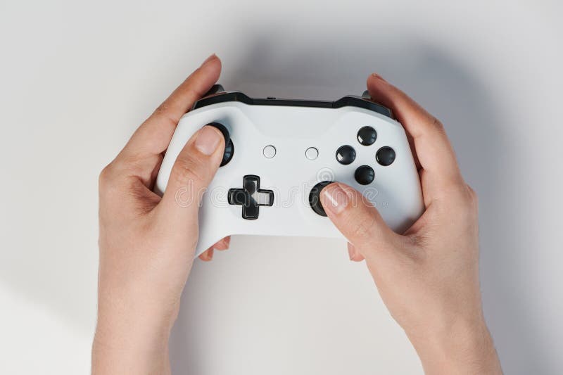 White Controller with Black Buttons in Hand Stock Photo - Image of ...