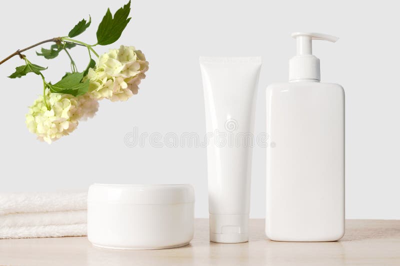 White Cosmetic Cream and Dispenser with White Towel and Hydrangea ...