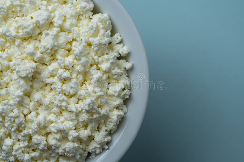White Cottage Cheese in Plate on Blue Background, Top View, Close Up ...