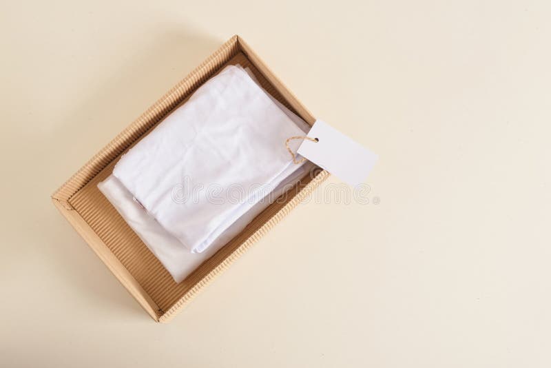 White Cotton Clothes in Craft Box and Blank White Paper Label Stock ...