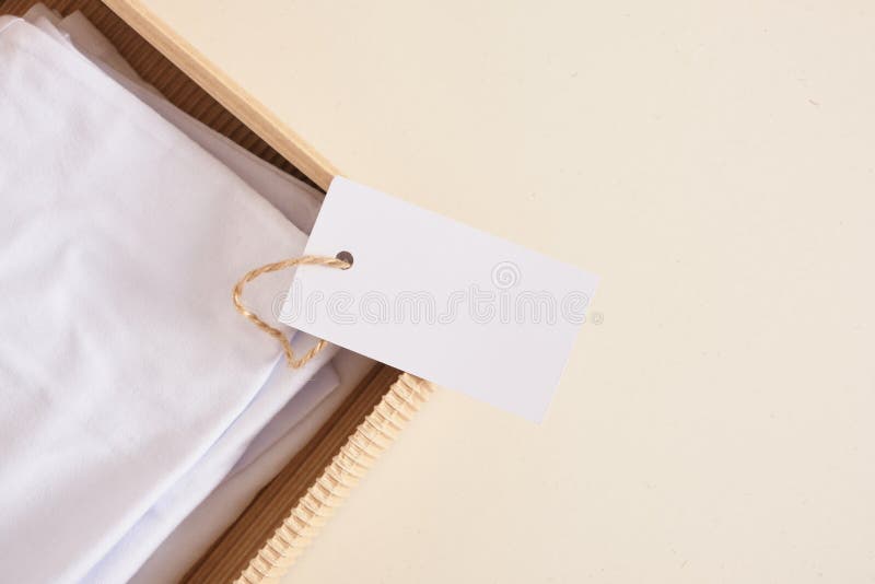 White Cotton Clothes in Craft Box and Blank White Paper Label Stock ...