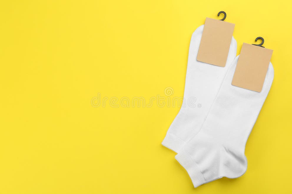 White Cotton Socks on Yellow Background, Flat Lay. Space for Text Stock ...