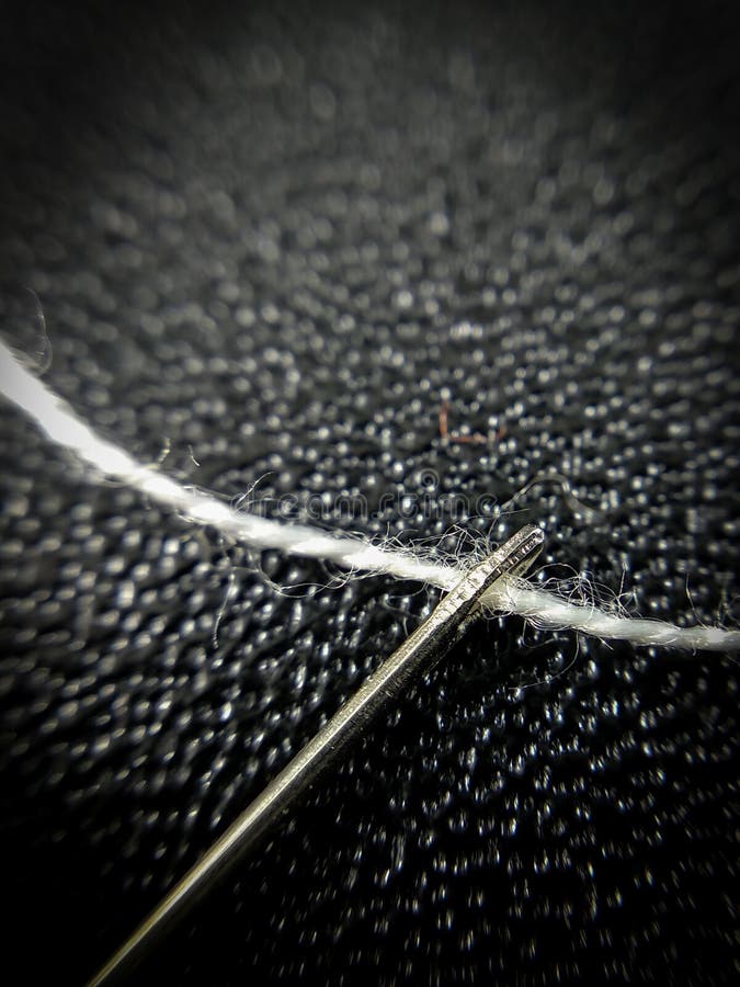 White Cotton Thread between Needle Hole on Black Abstract Background ...