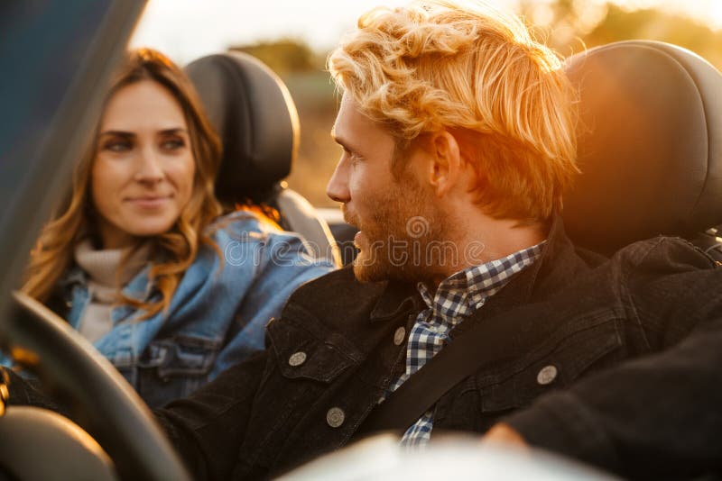 White Couple Smiling Together while Driving in Car during Trip Stock ...