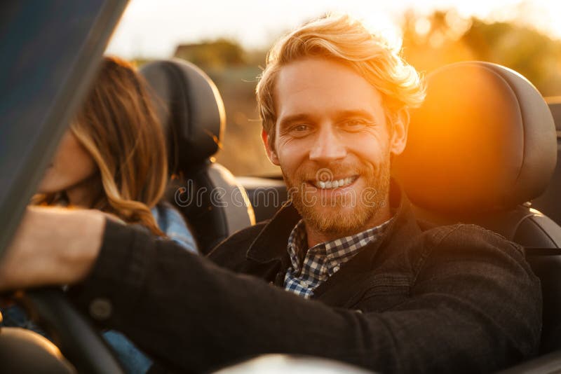 White Couple Smiling Together while Driving in Car during Trip Stock ...