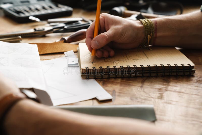 White Craftsman Drawing while Working with Leather Stock Image - Image ...