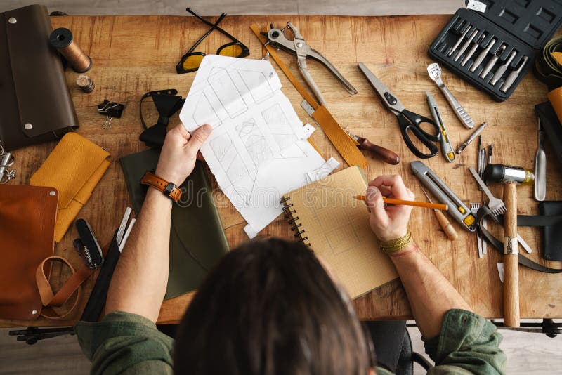 White Craftsman Drawing while Working with Leather Stock Photo - Image ...