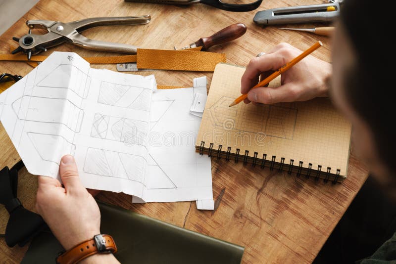 White Craftsman Drawing while Working with Leather Stock Photo - Image ...