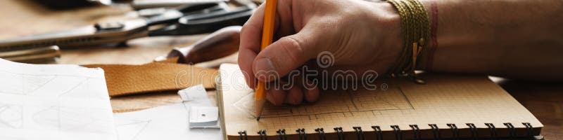 Craftsman Drawing while Working with Leather in Workshop Stock Photo ...